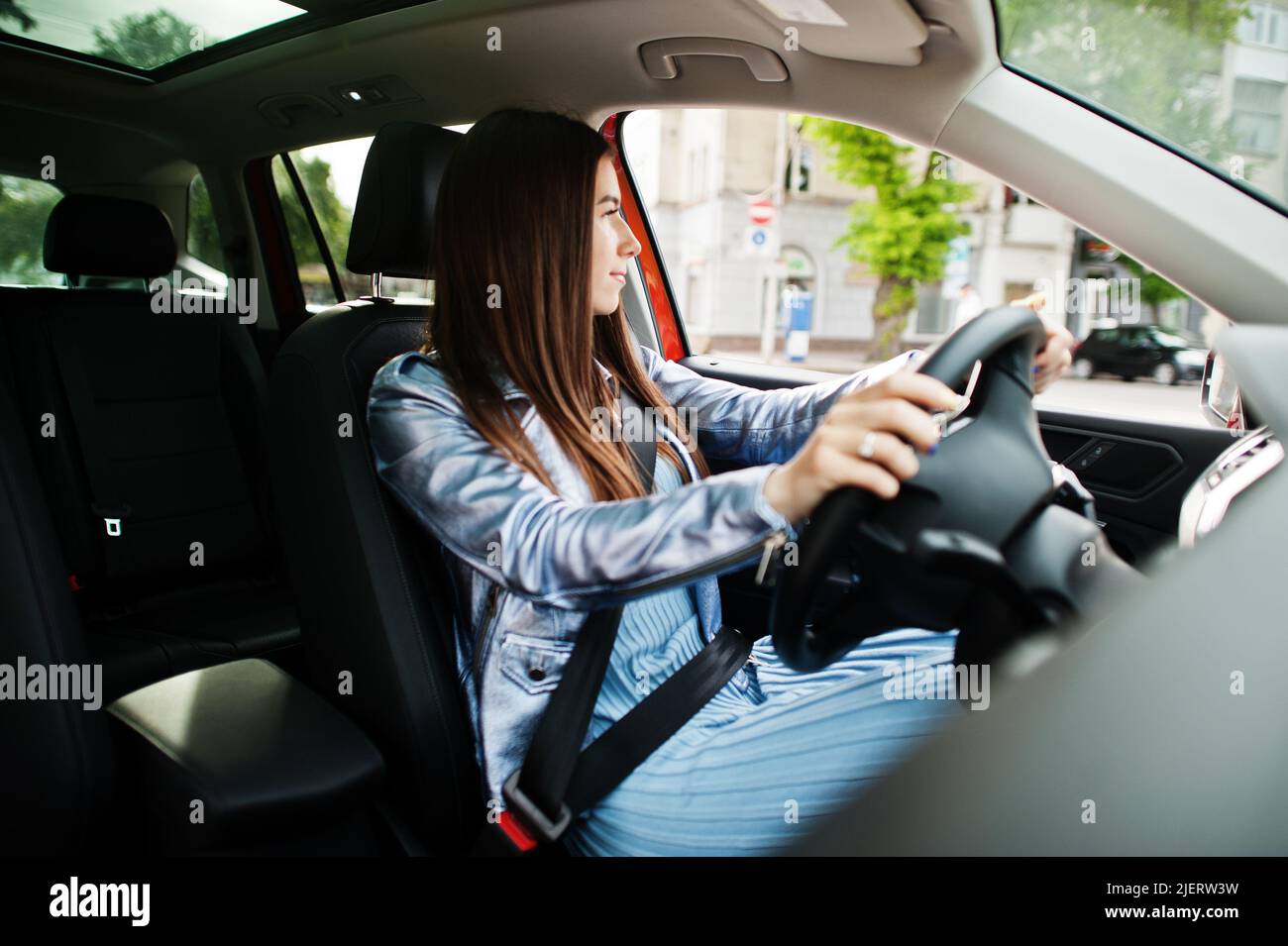 Gorgeous woman sitting inside car interior Stock Photo - Alamy