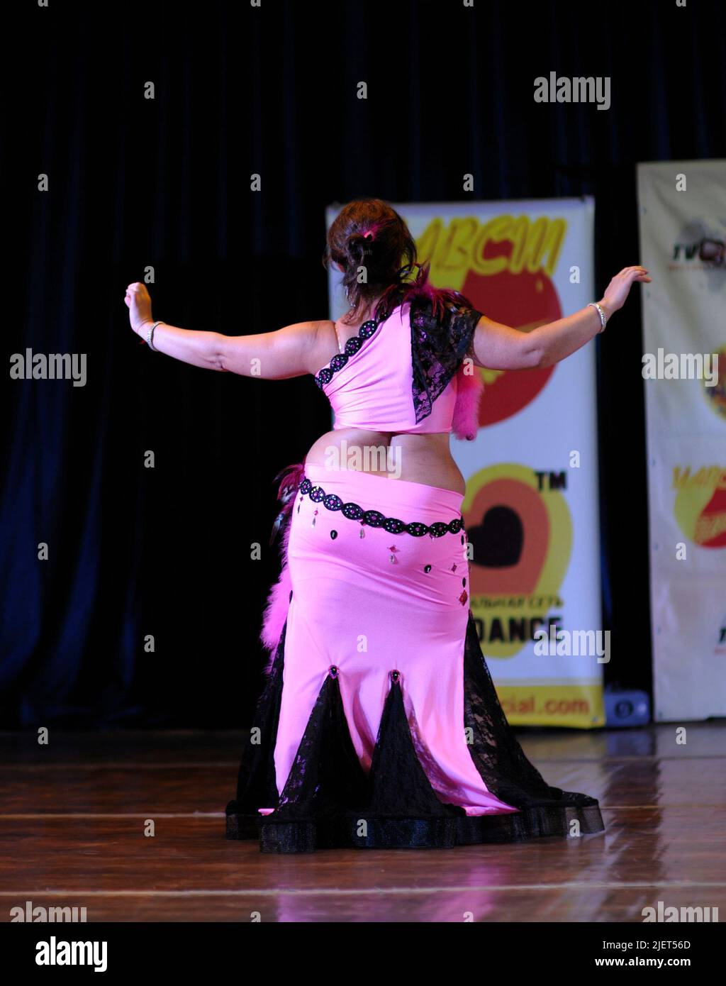 Body positive woman dancer performing belly dance on stage. Festival ...