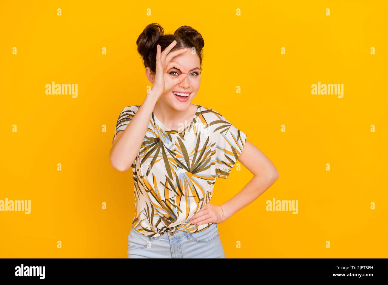 Photo of funky sweet lady dressed print t-shirt looking through okey ...