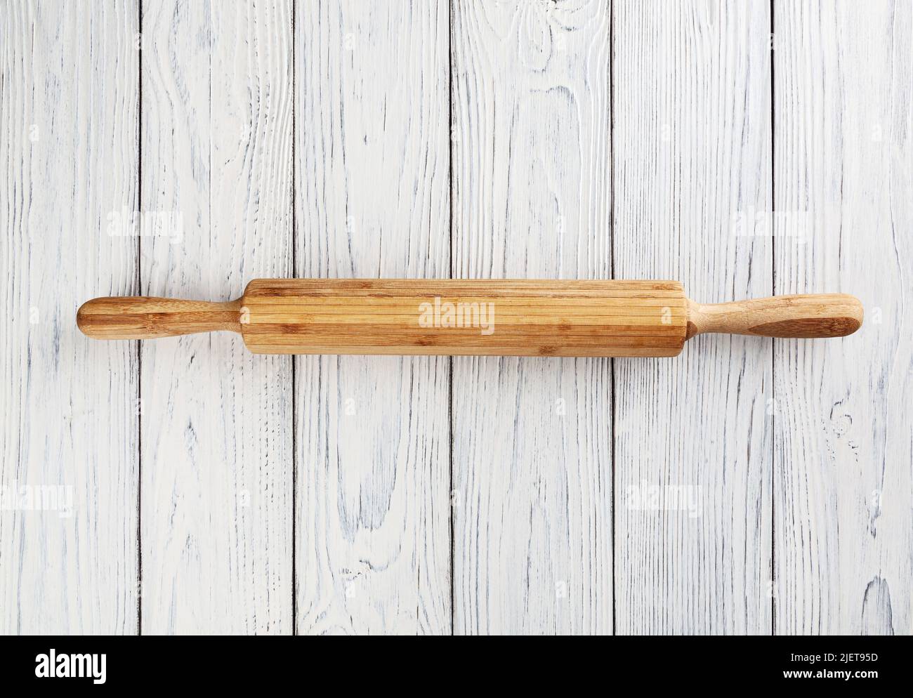 Rolling pin on white wooden table Stock Photo - Alamy