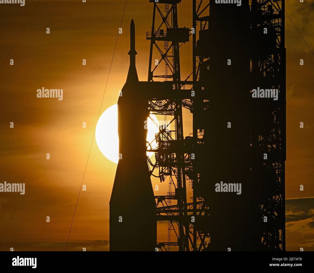 The sun sets behind NASA's Space Launch System (SLS) rocket as it ...