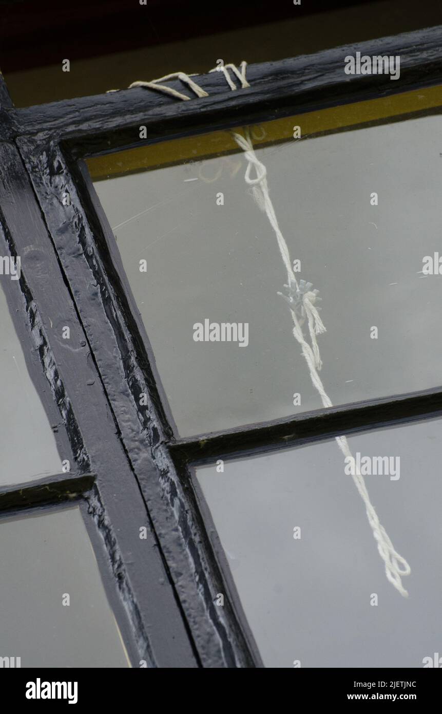 string hanging from blackpainted vintage house window frame Stock Photo ...