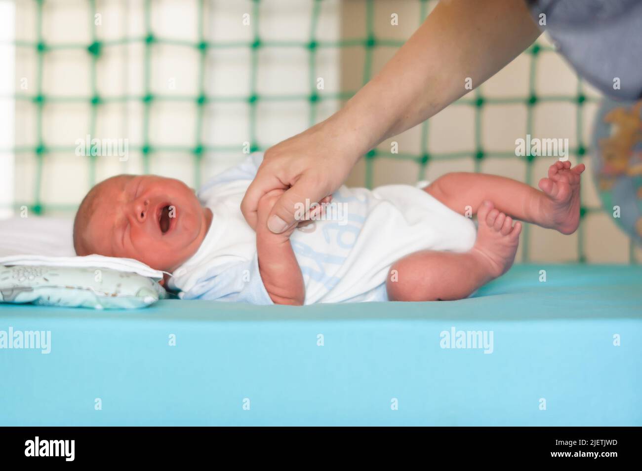 Sweet and cute small little newborn baby cry strongly while caring ...