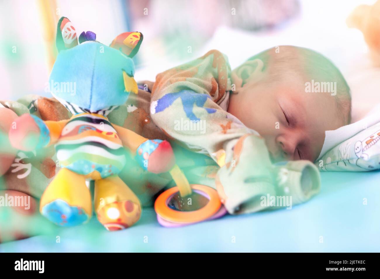 Cute little peaceful baby calm sleeps soundly in his crib with his baby ...