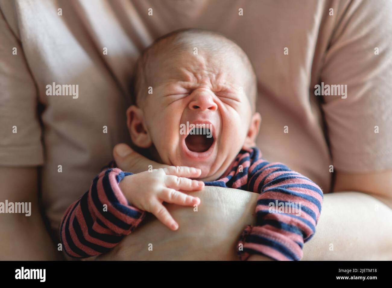 Sweet and cute small little newborn baby is hungry and upset and cry ...