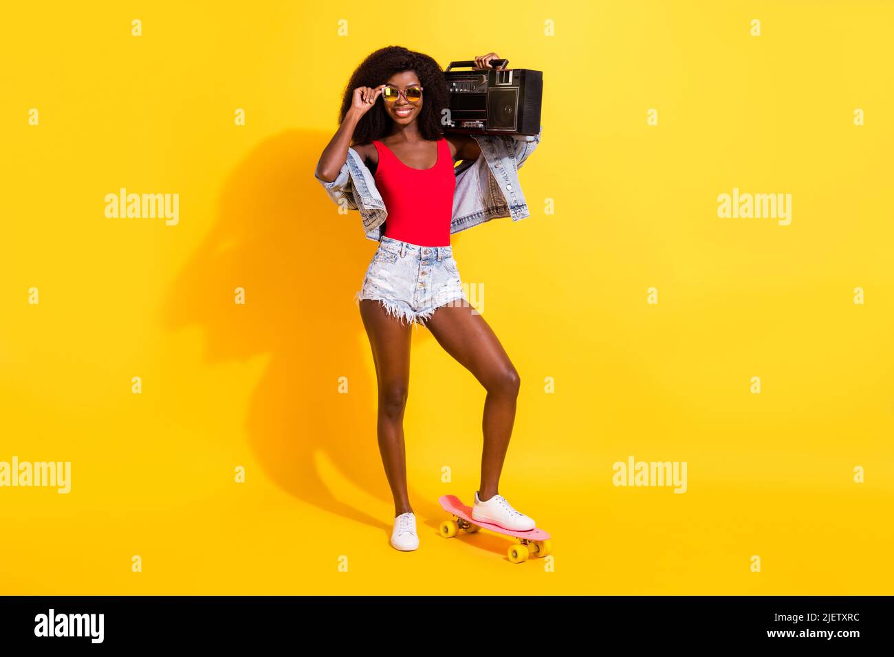 Full length body size view of attractive cheerful girl carrying player ...