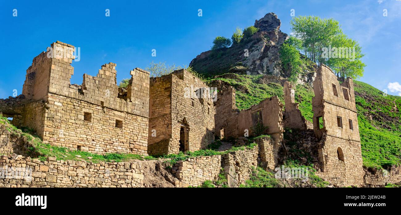 ruins of ancient stone buildings under the rocks in the abandoned ...