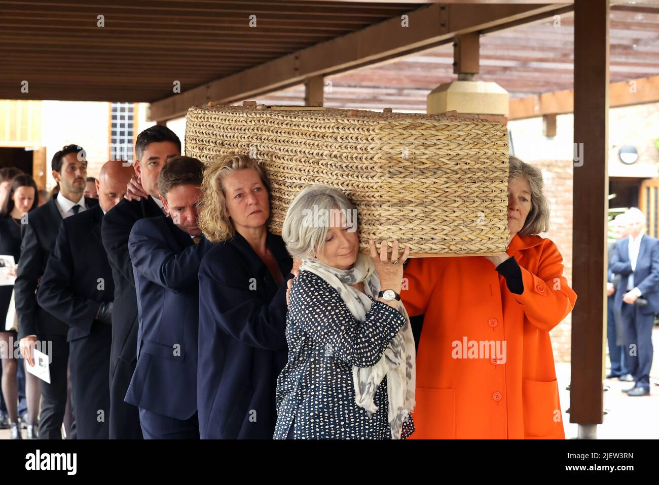 Mourners carry a coffin after the funeral of long-time owner of the ...