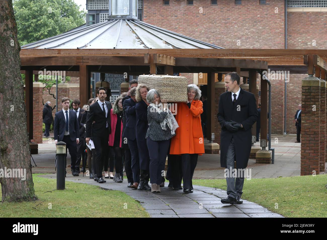 Mourners carry a coffin after the funeral of long-time owner of the ...