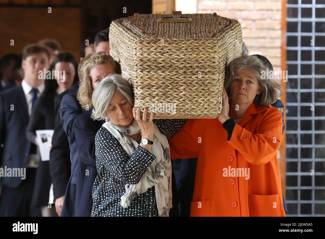 Mourners carry a coffin after the funeral of long-time owner of the ...
