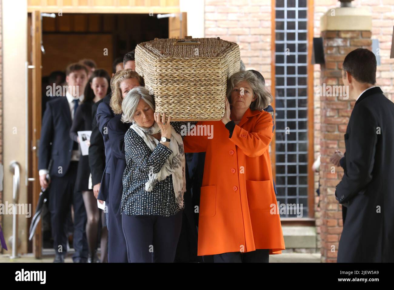 Mourners carry a coffin after the funeral of long-time owner of the ...