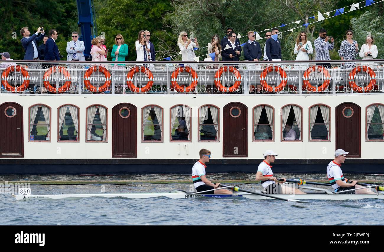 People on the New Orleans Paddle Steamer Boat look on as a rowing crew ...