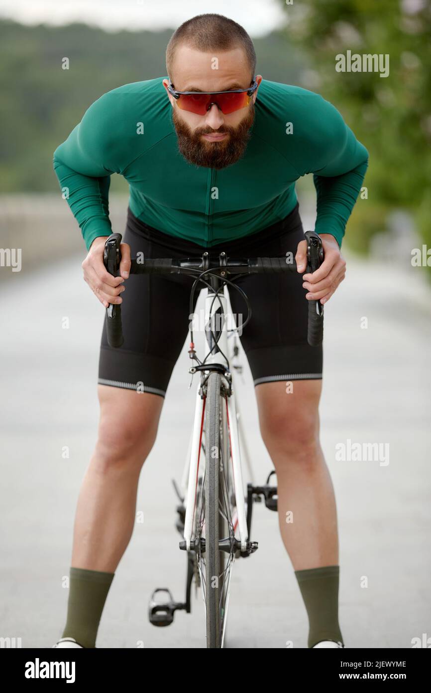 A cyclist in motion. Bike ride along the embankment along the river ...