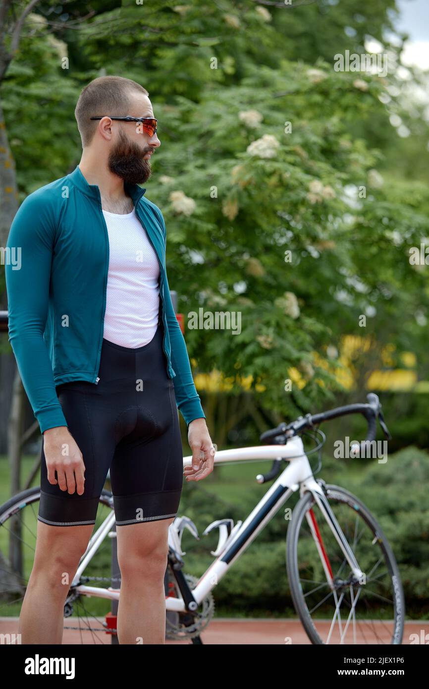 Cyclist on sportground relaxing alone around nature, taking break to ...