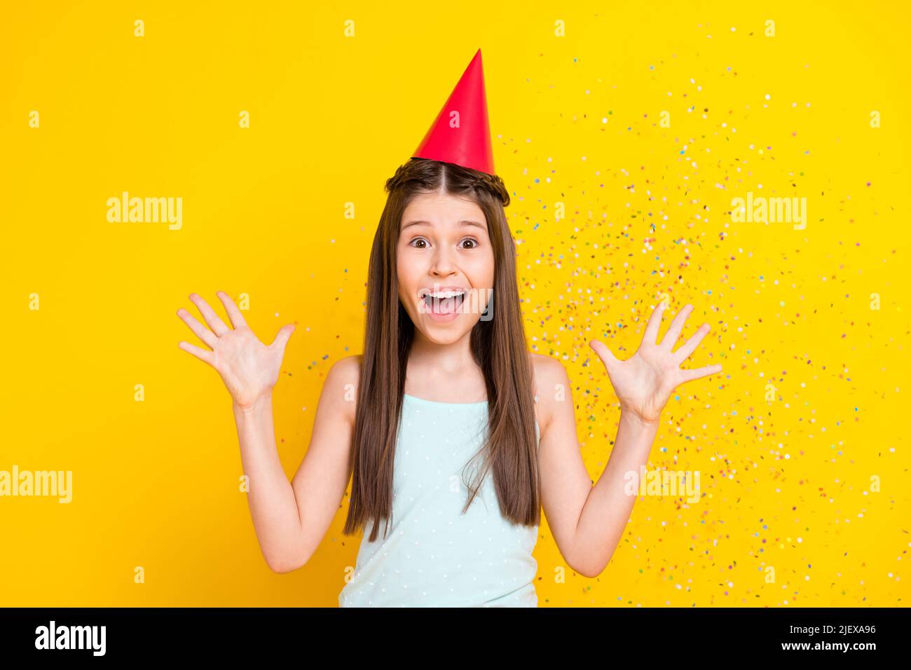 Portrait of attractive funky cheerful dreamy girl throwing confetti ...