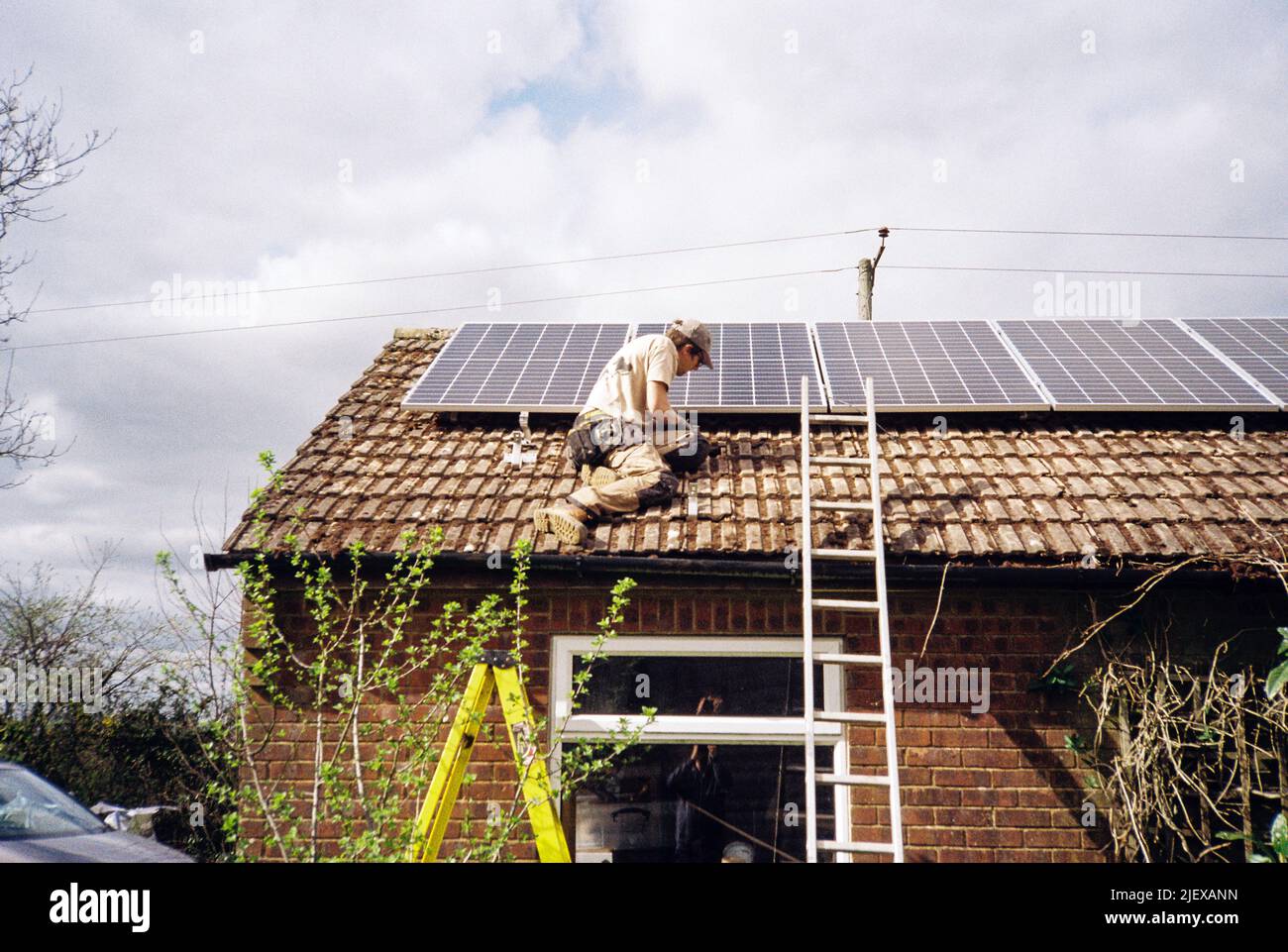 Solar panels being installed on garage roof, Hampshire, England, United ...