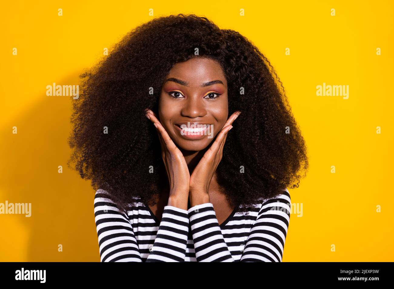 Photo portrait of young model smiling touching cheeks in striped shirt ...