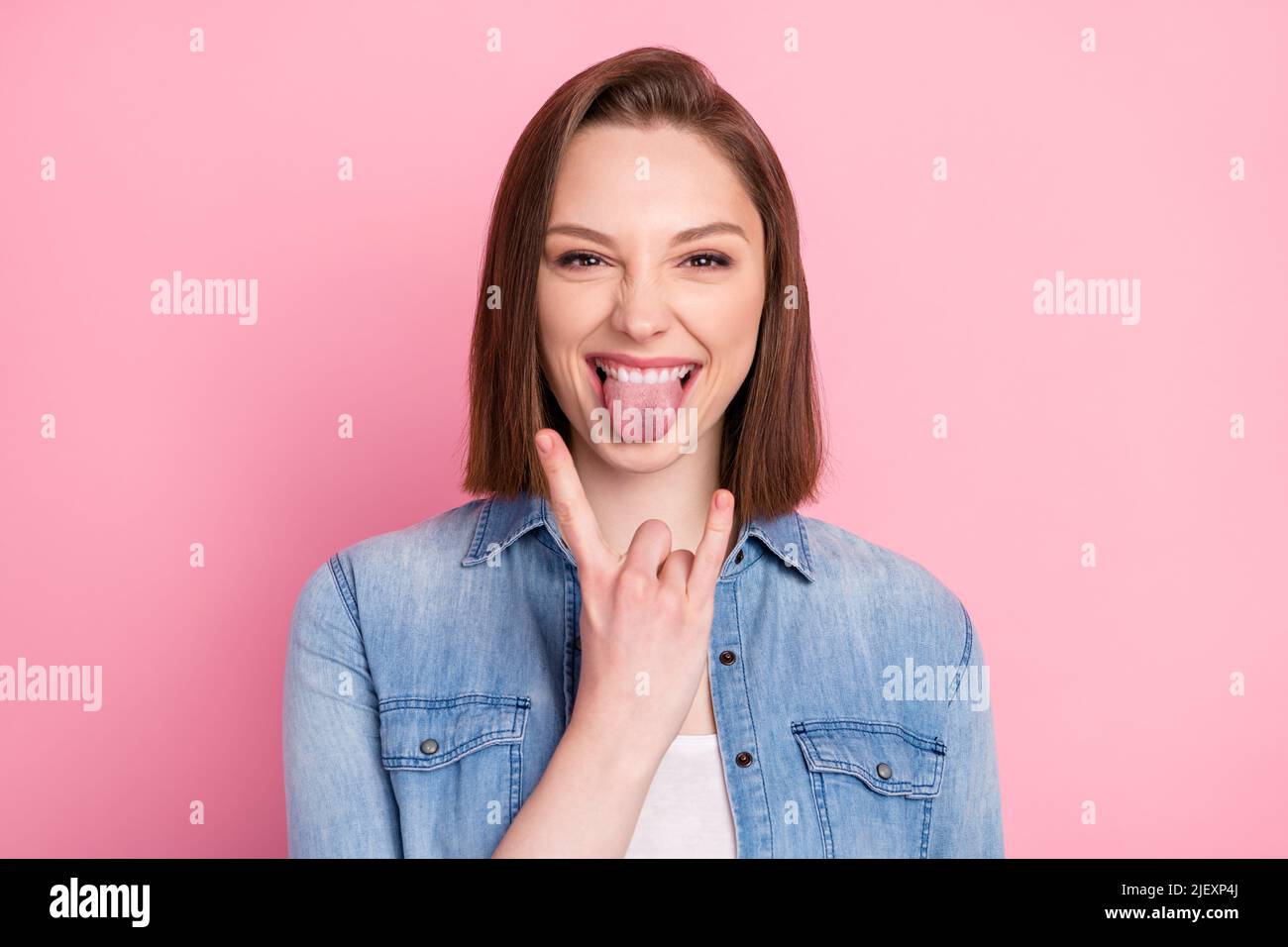 Photo portrait of girl smiling showing heavy metal sign isolated pastel ...