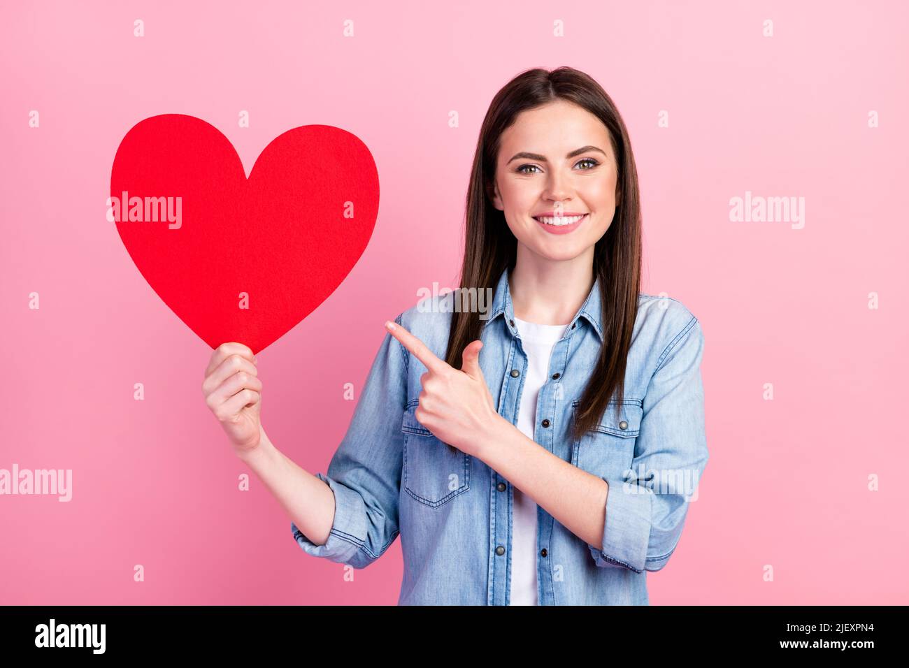 Photo portrait of female student pointing finger on red heart isolated ...