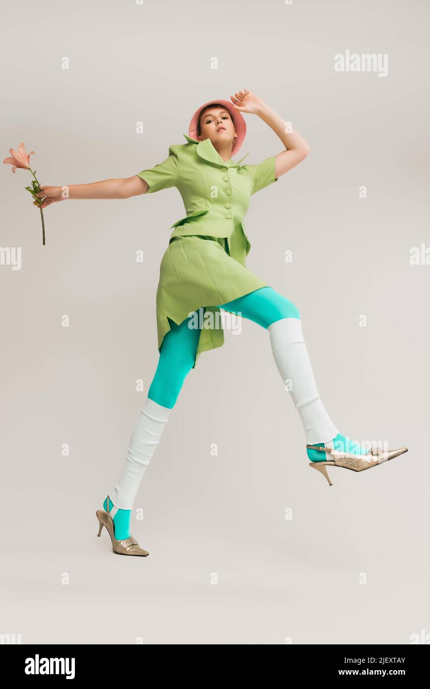 Portrait of young extraordinary girl in colorful outfit with green suit ...
