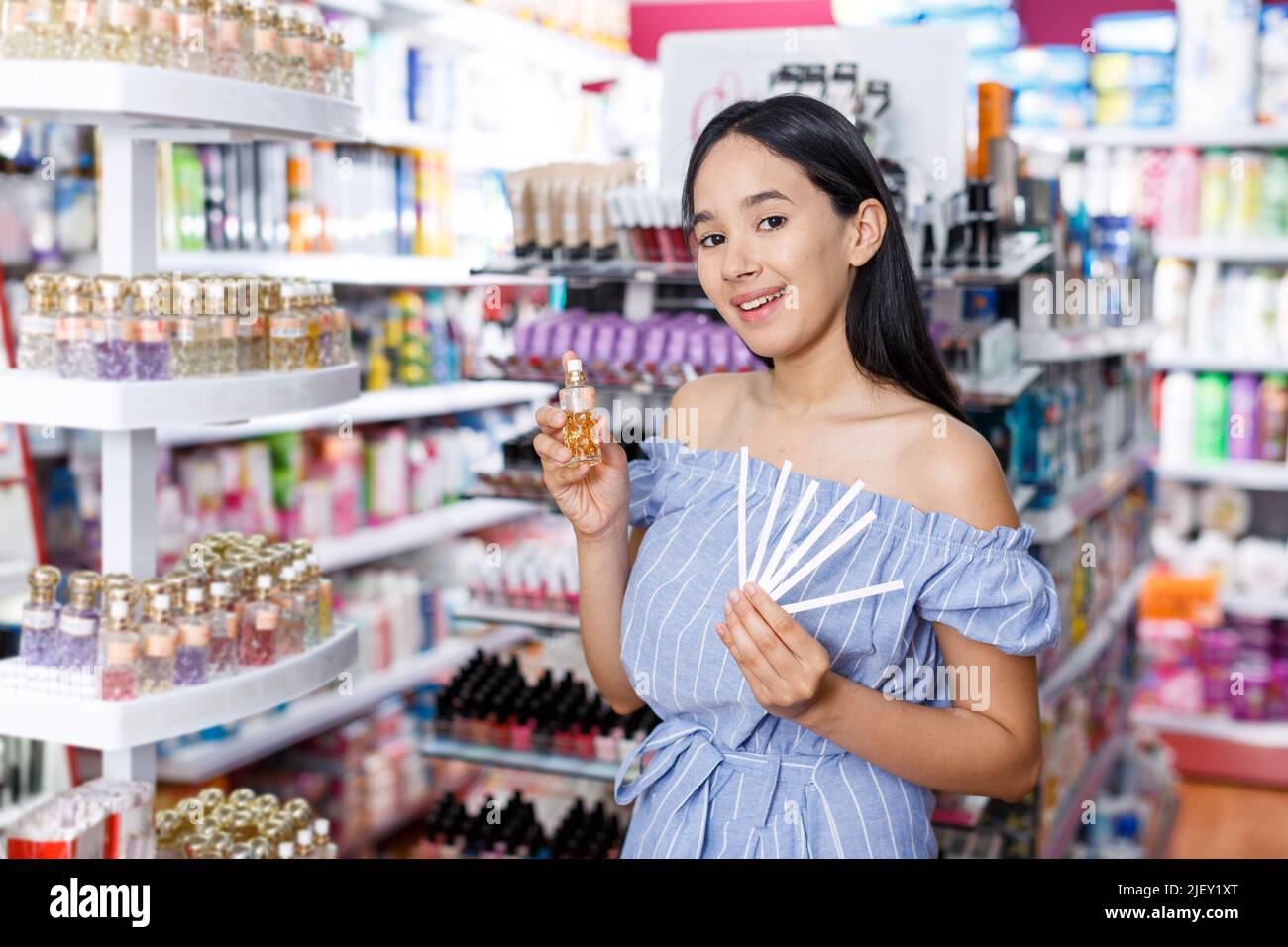 Girl with testers in perfumery, choosing perfume in cosmetic shop Stock ...