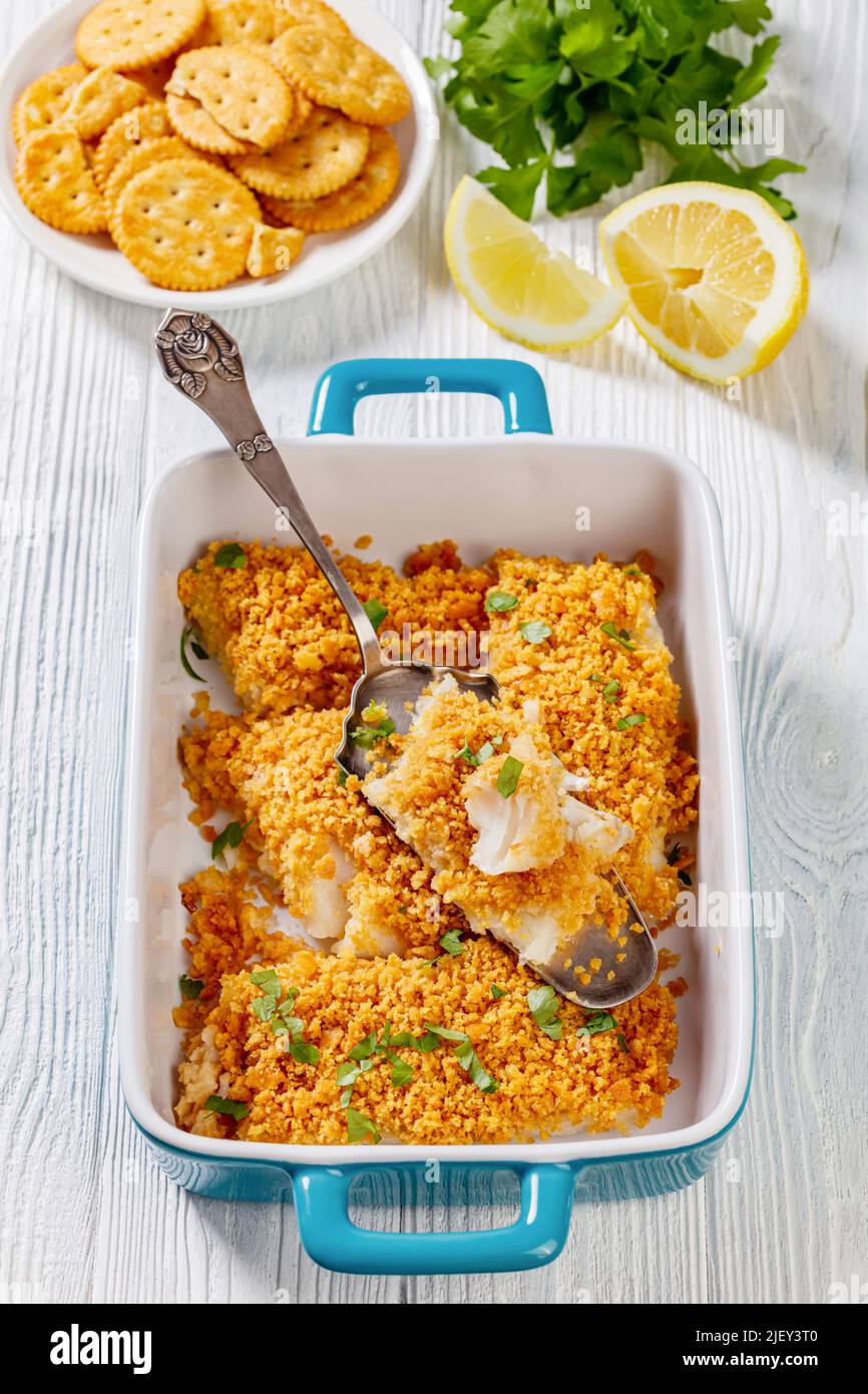 Baked Cod with Crackers butter toppings in blue baking dish on white ...