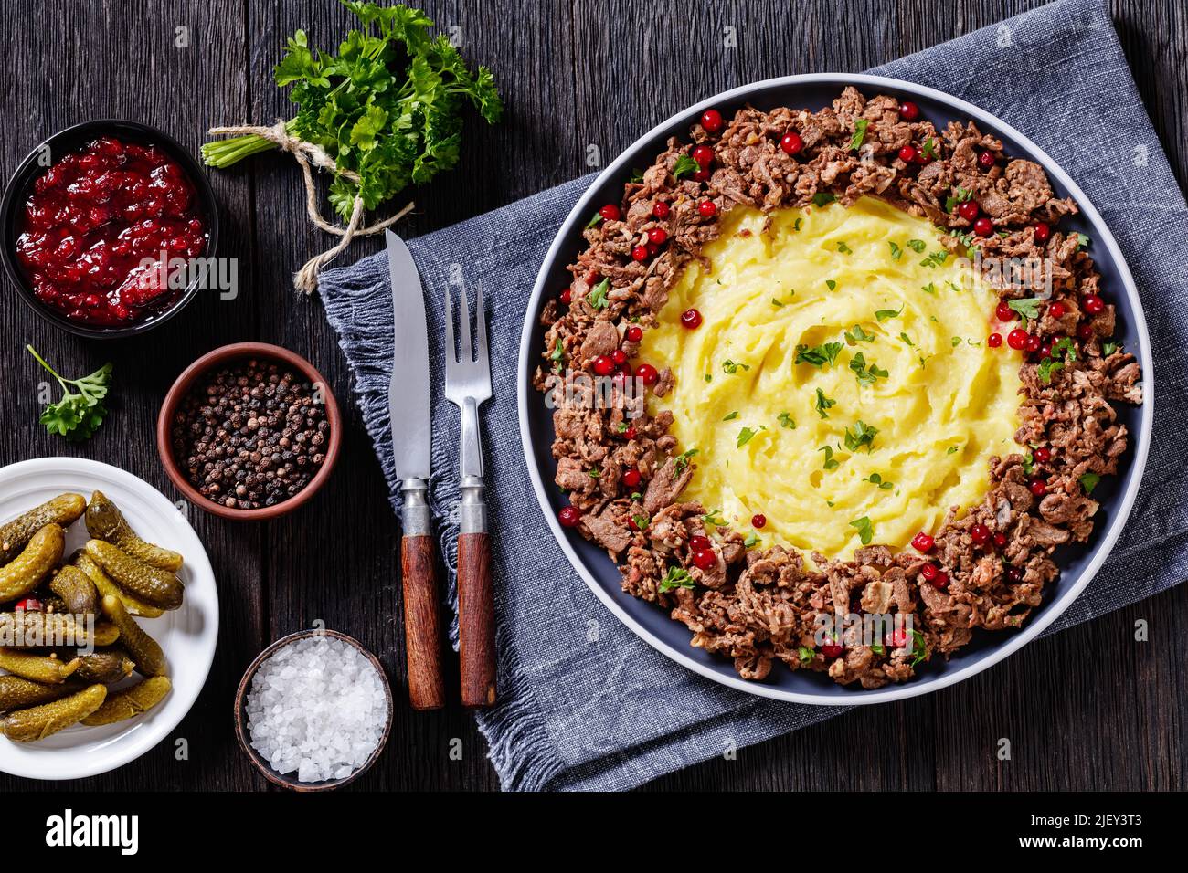 Reindeer Stew with Lingonberries and potato puree on plate on wood ...
