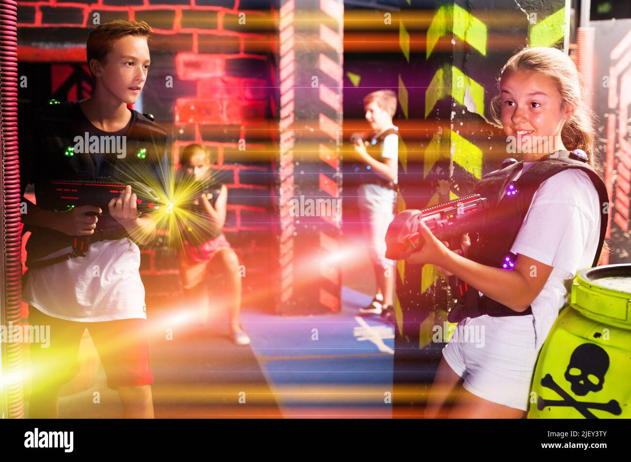 Girls and boys playing laser tag Stock Photo - Alamy