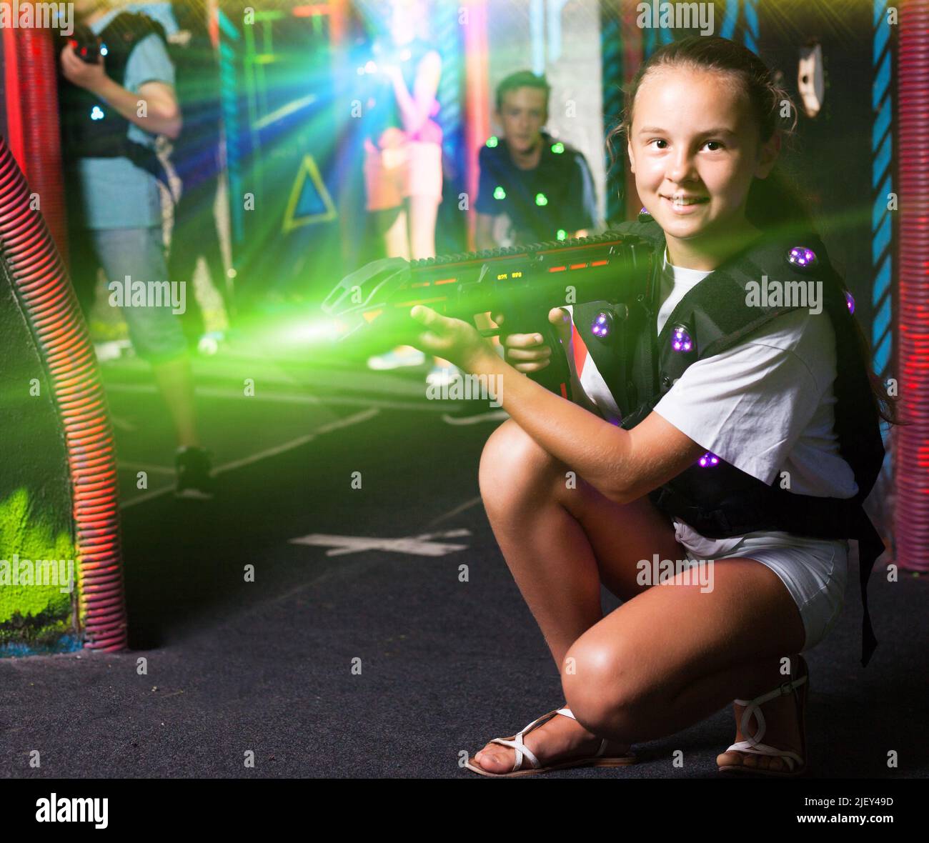 Girl playing laser tag Stock Photo - Alamy