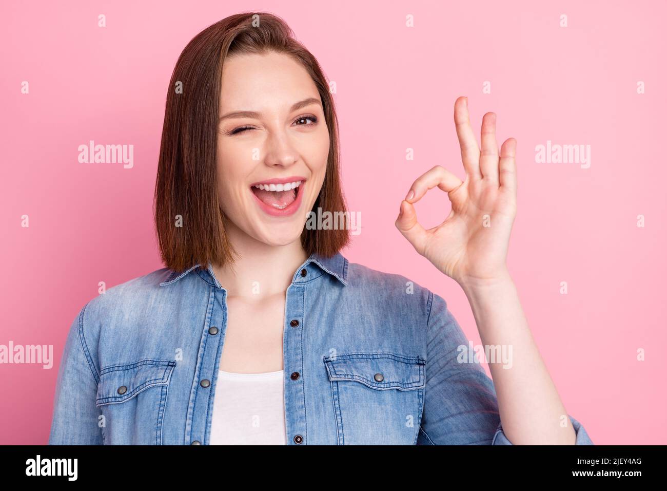 Photo portrait of girl smiling showing okay sign winking blinking ...