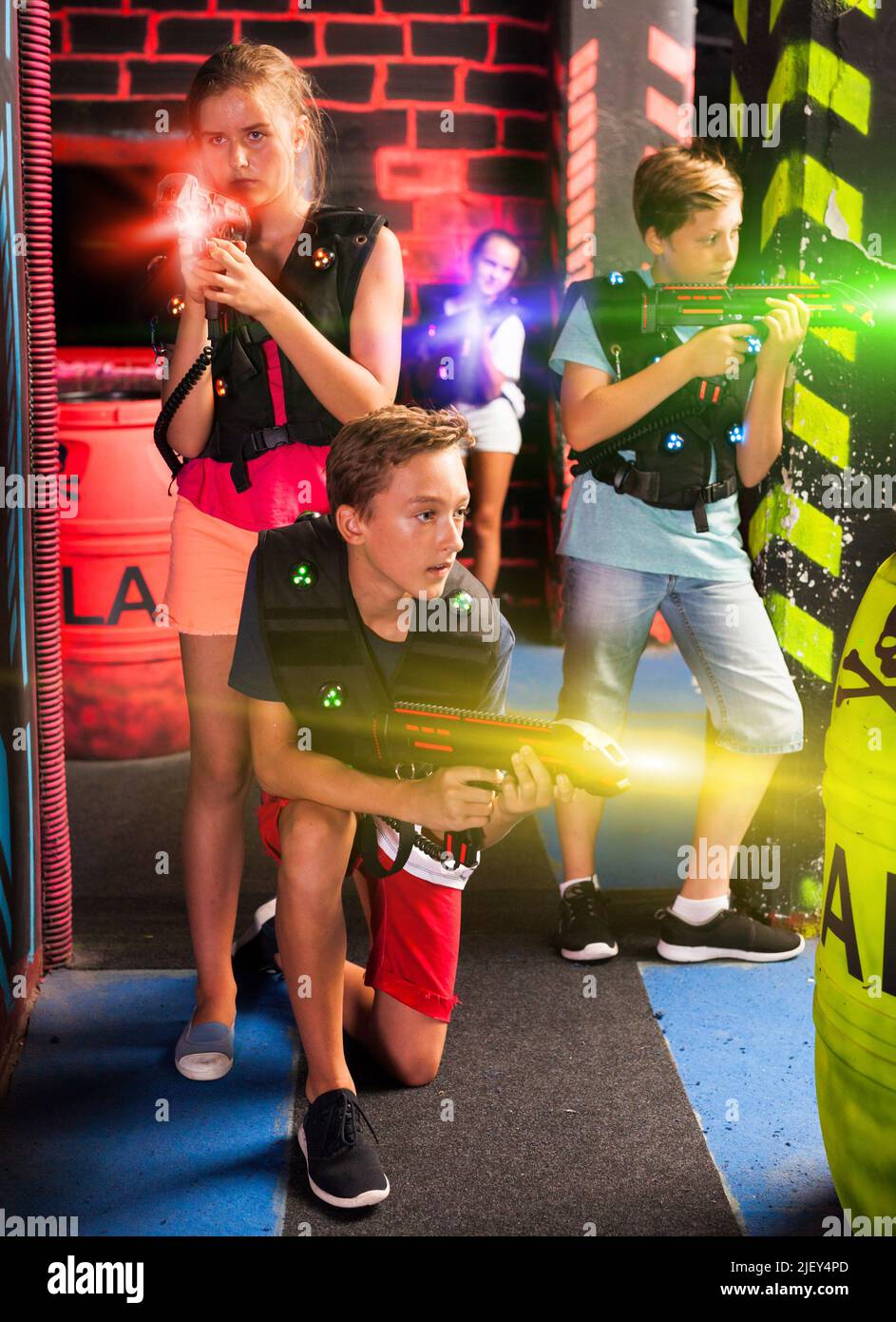 Girls and boys playing laser tag Stock Photo - Alamy