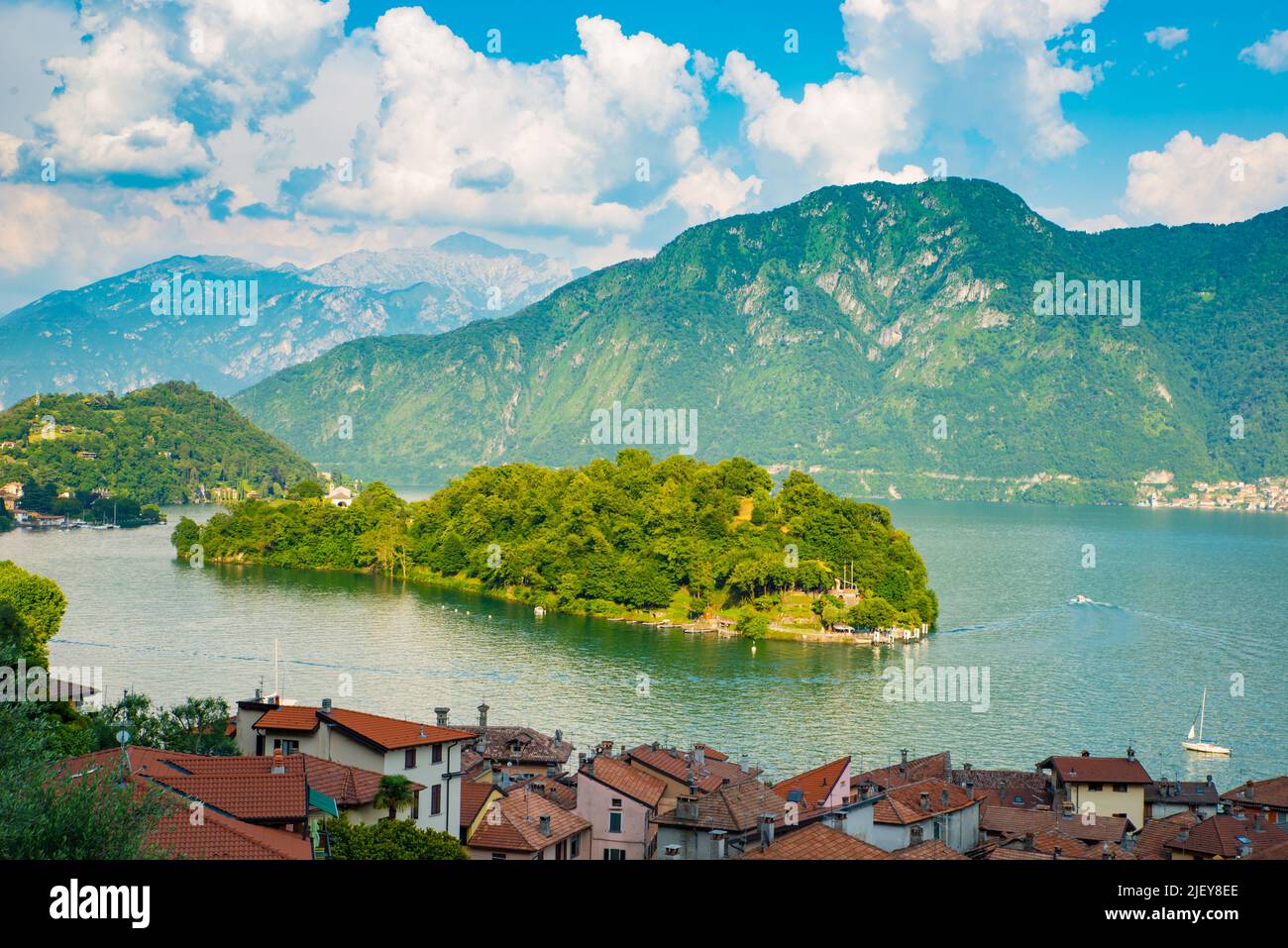 Comacina Island, photographed in a spring, with boats and piers around ...