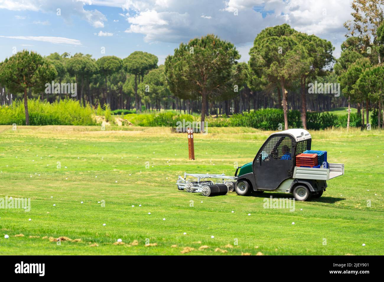 Golf course and golf cart collecting golf balls. Ballpicker on driving ...