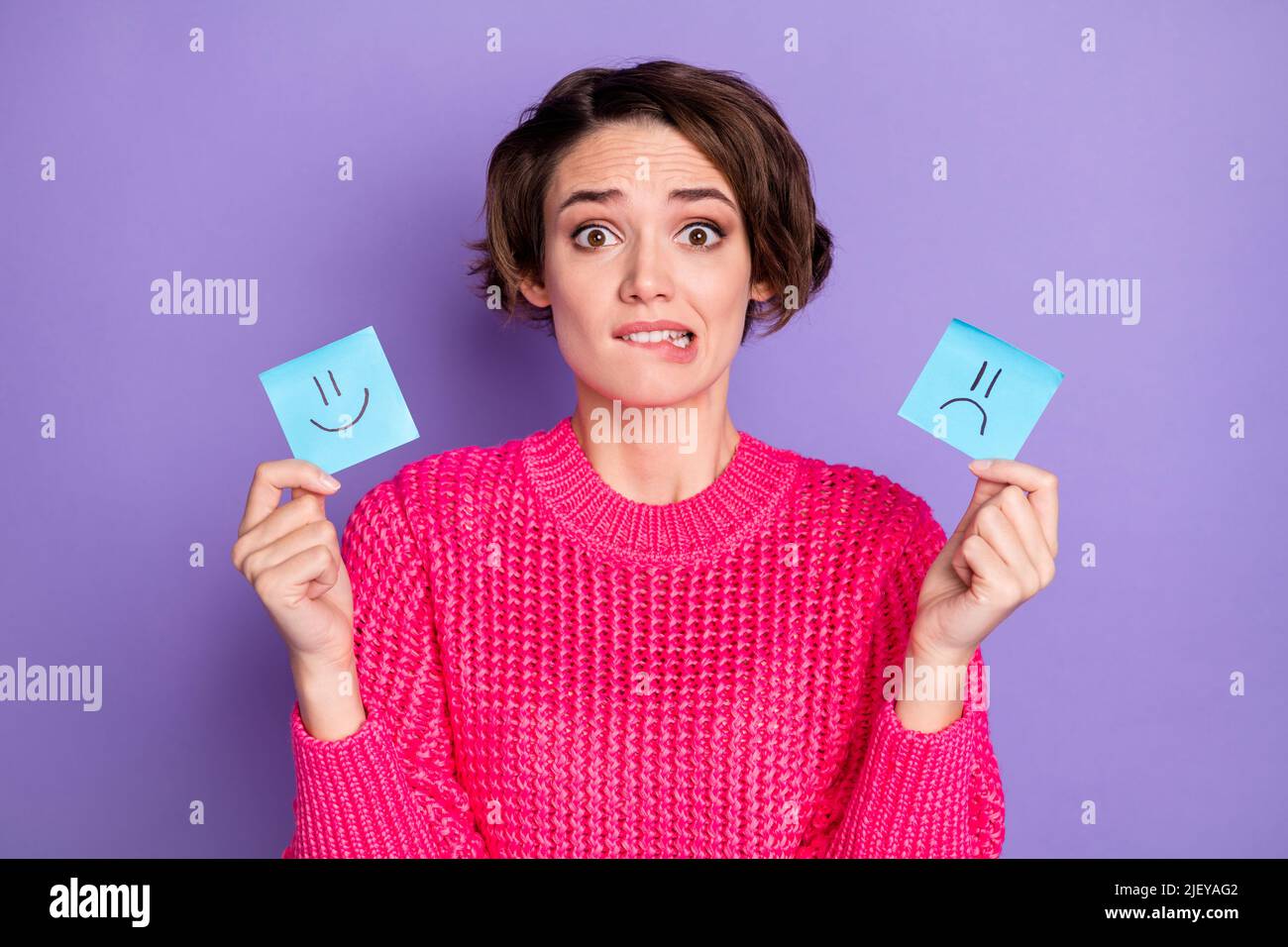 Photo of young girl bite lips confused dilemma choice hold positive ...