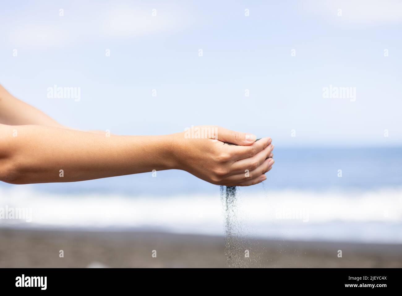 Female hands with sand. Summer holidays and vacation concept. Close up ...