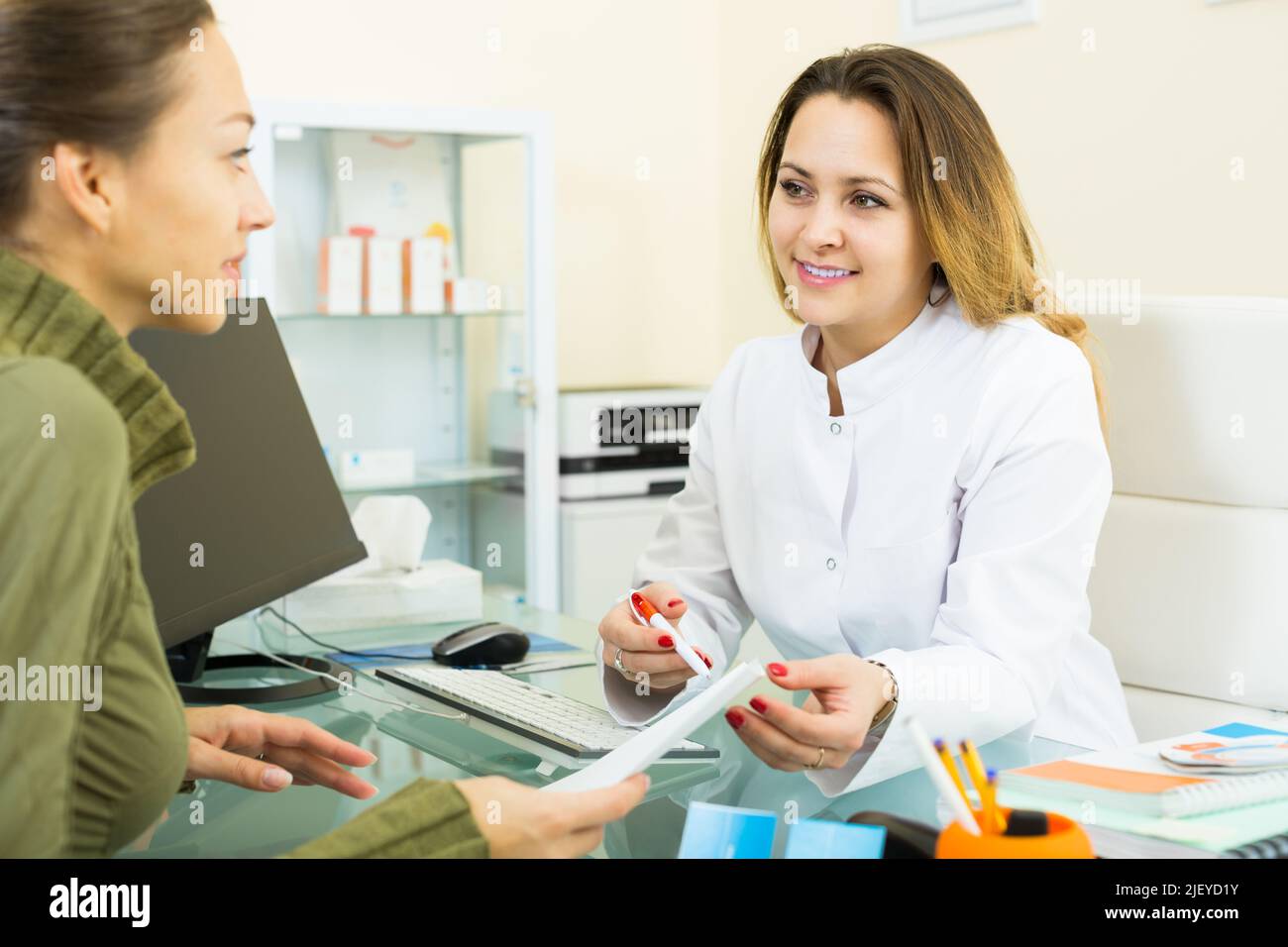 Female doctor consulting client in medicine center Stock Photo - Alamy