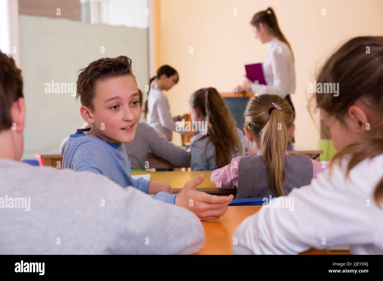Group of school children discussing hi-res stock photography and images ...