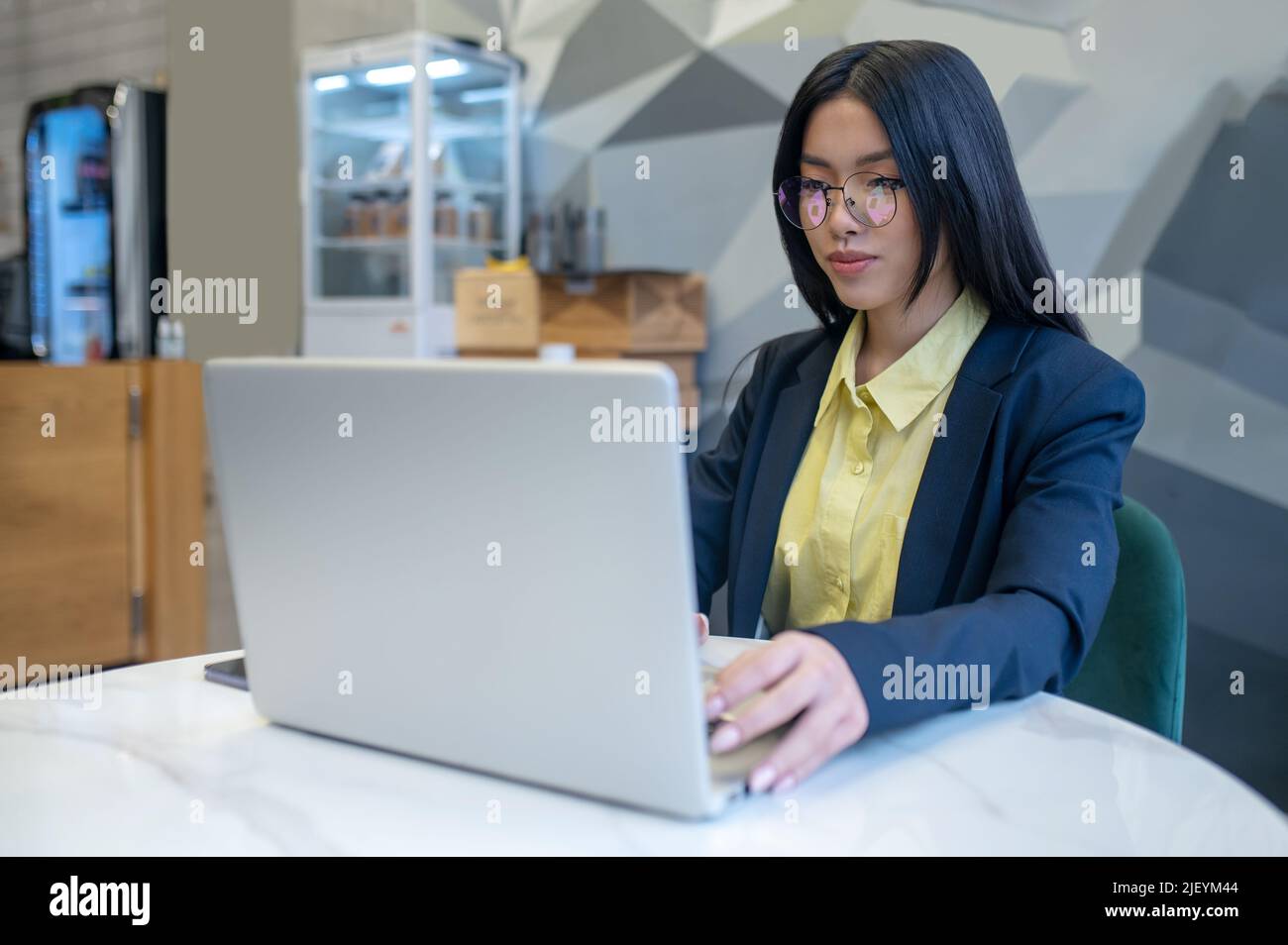 Positive asian woman looking laptop hi-res stock photography and images ...