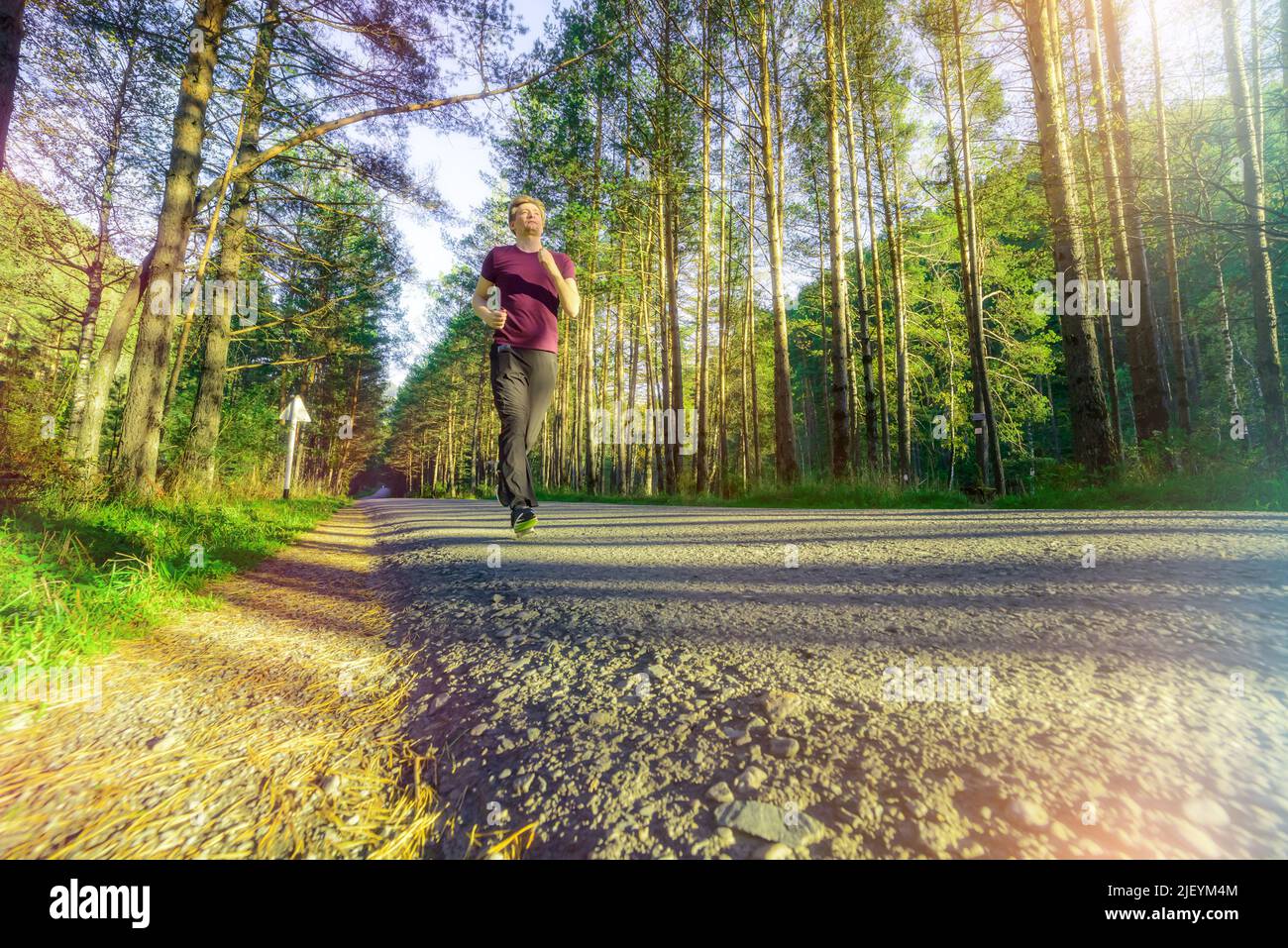 Running man jogging in city park at beautiful summer day. Sport fitness ...
