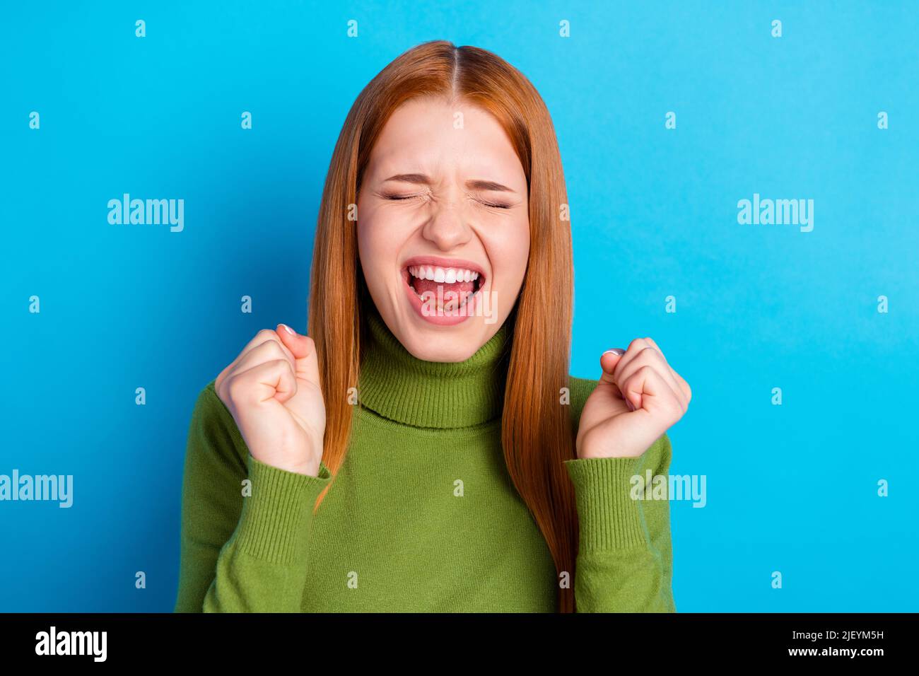 Photo portrait of pretty girl overjoyed gesturing like winner isolated ...