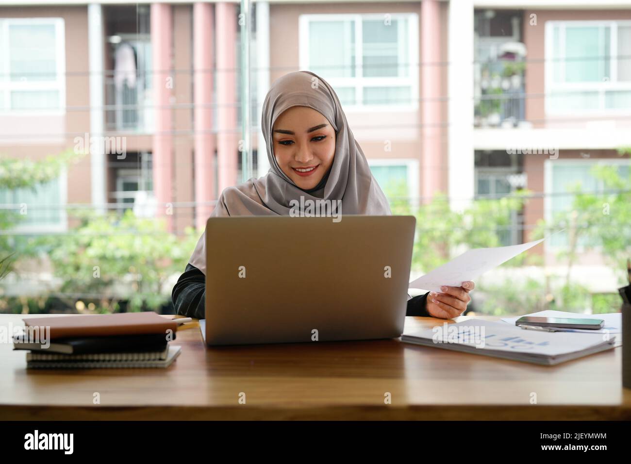 Portrait asian muslim woman manager working with laptop computer for ...