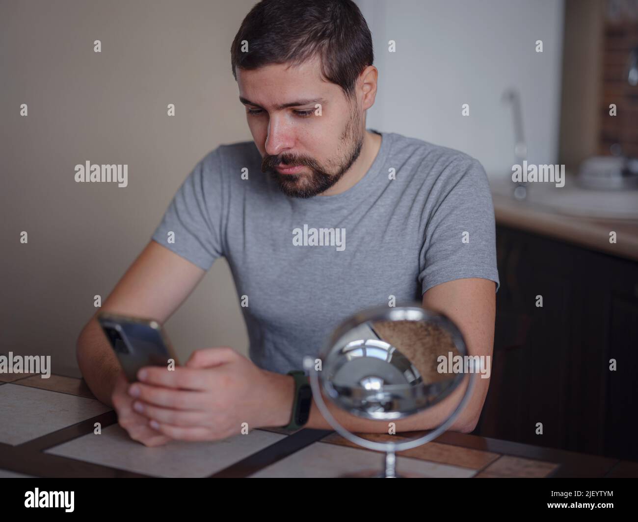 guy checking his skin. Young man looking in mirror touches face with ...