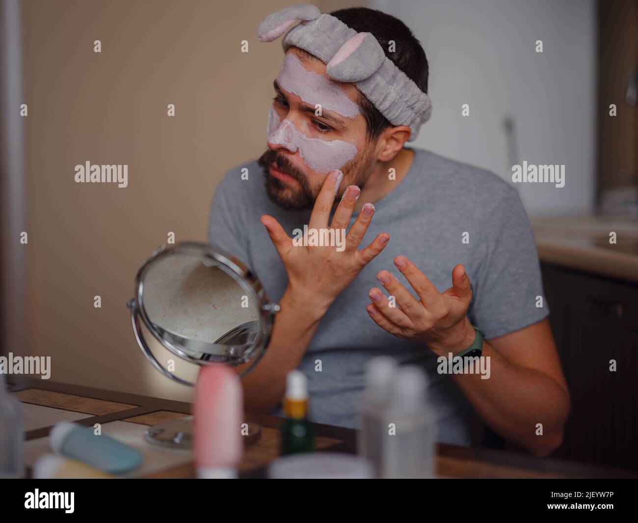 Men's beauty concept. caucAsian guy checking his skin. man looking into ...