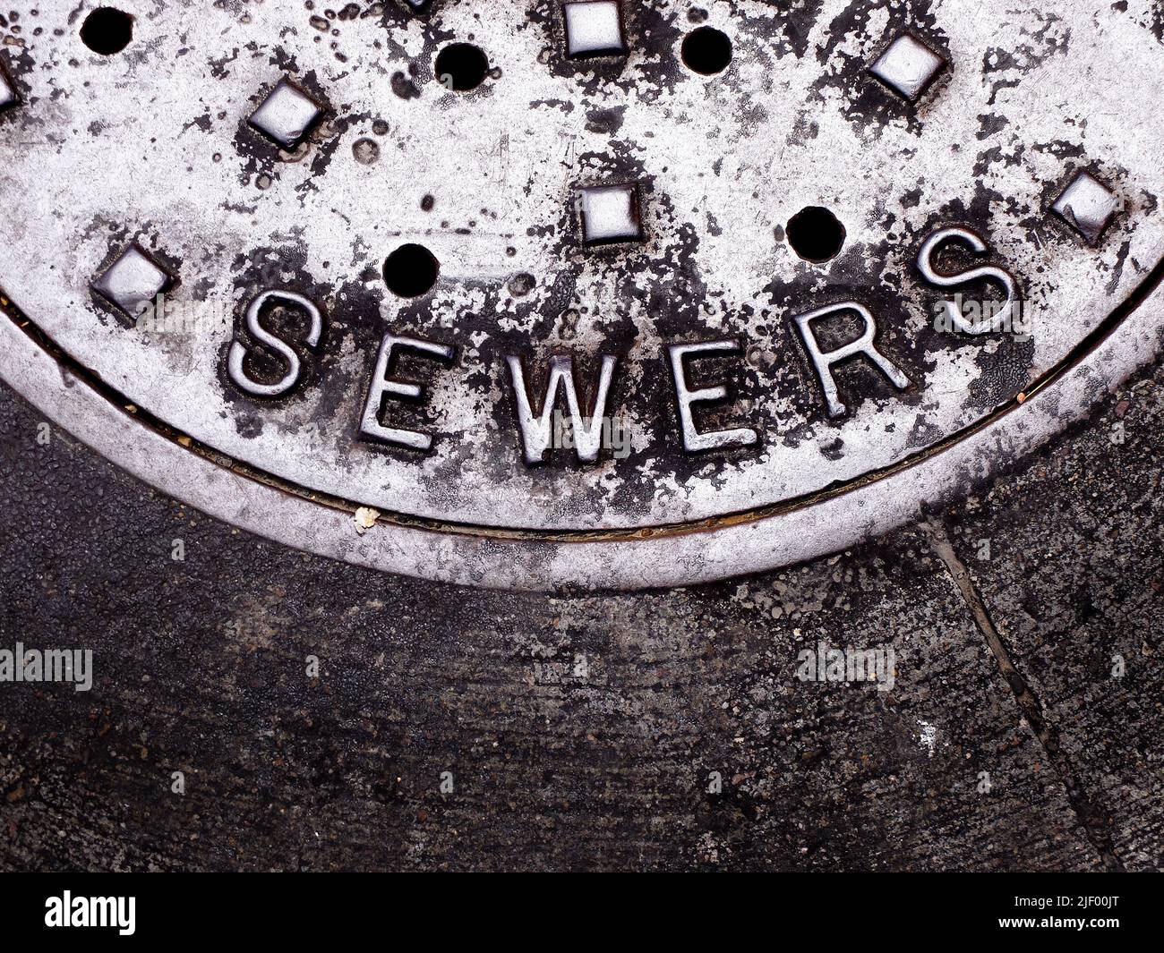 Sewer man hole cover of an iron lid for access to sewer lines Stock ...