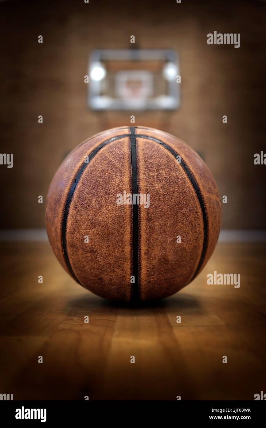 Basketball court with ball hoops rims hardwood floor and lights for ...