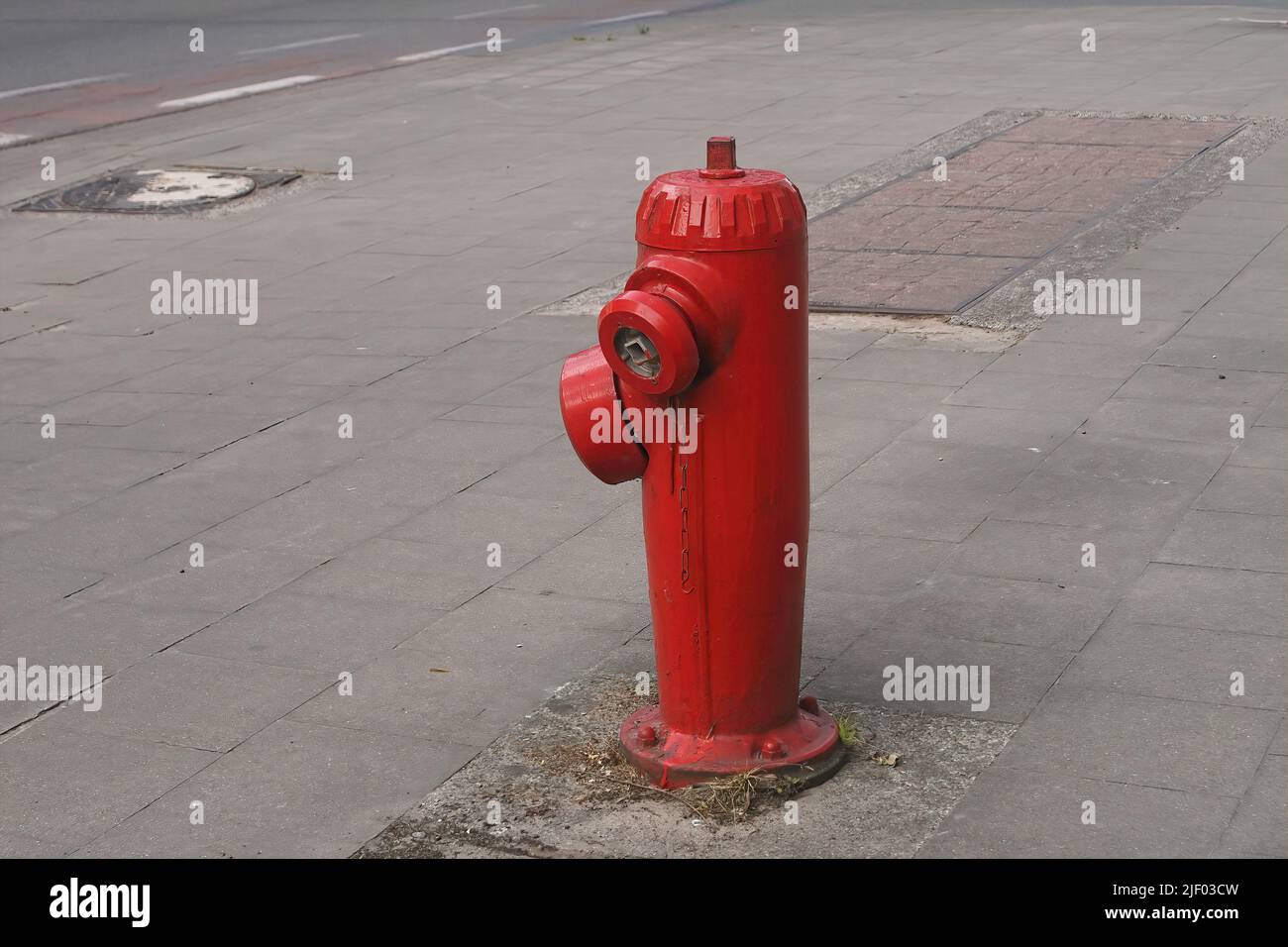Closeup on a flashy red fire hydrant at the side walk in Brussel ...