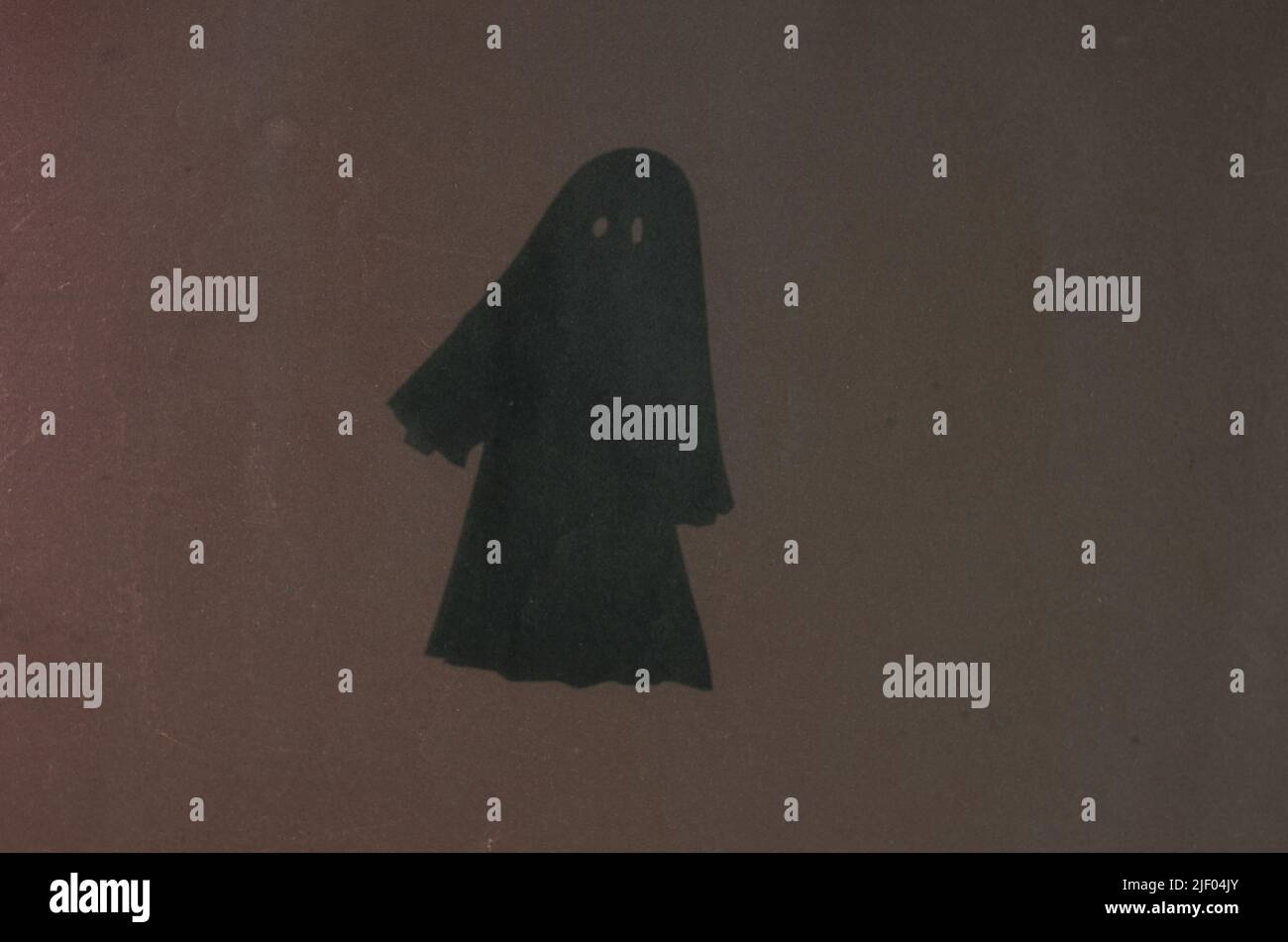 Shadow of a ghost against a gray background. Halloween paraphernalia ...