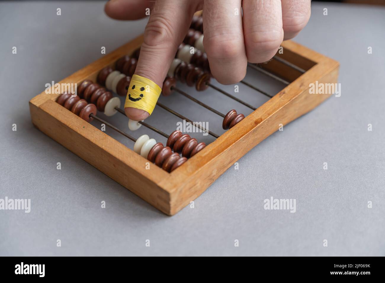 The accountant makes calculations on small wooden abacus. The man's ...