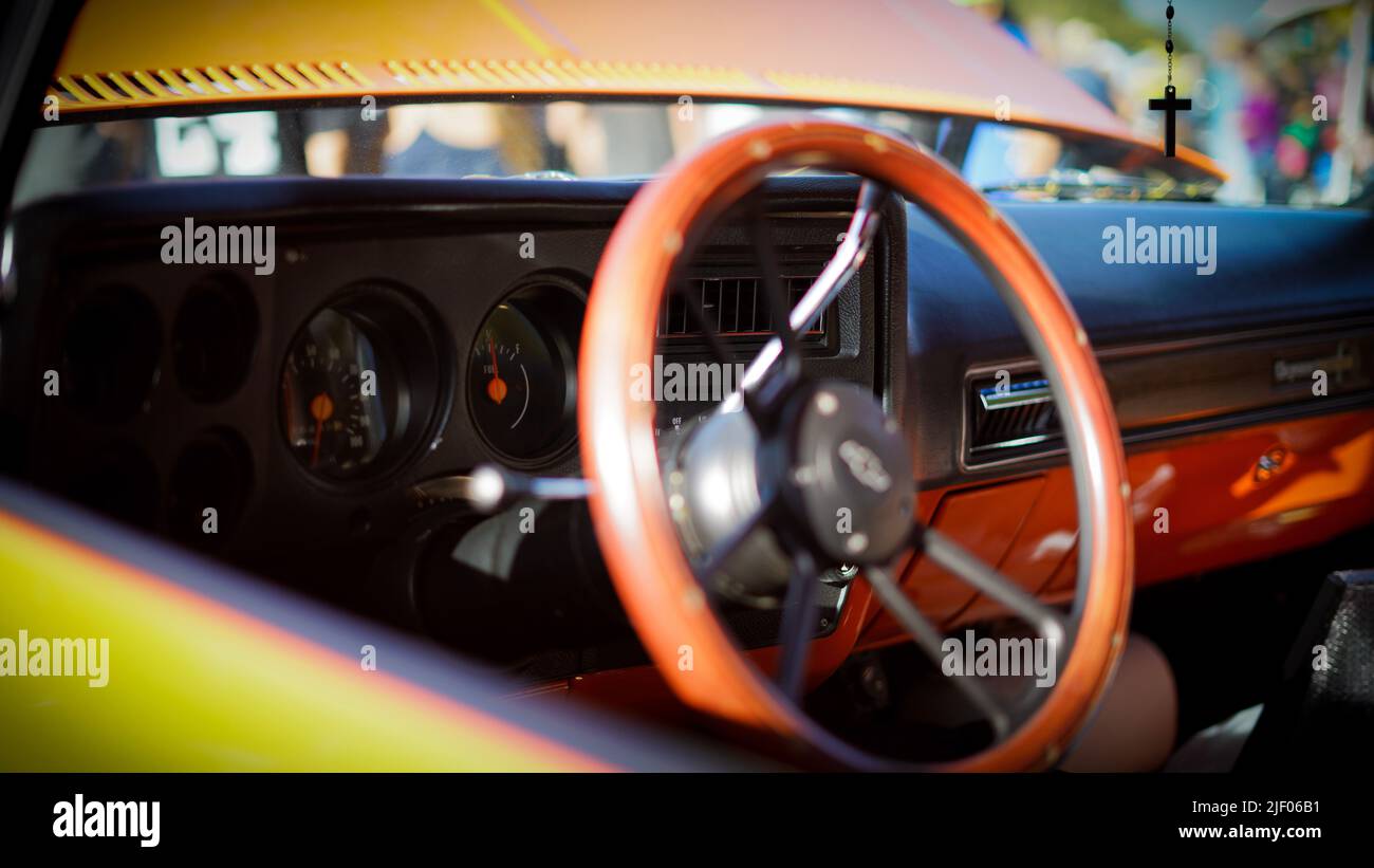 An orange pickup Chevrolet Cheyenne interior wheel in a classic car ...