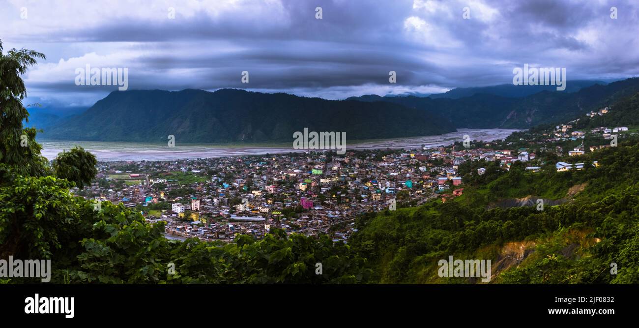 A panoramic shot of the cityscape of Bhutan and mountains under a gray ...